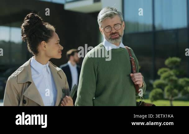 Portrait two business people walking talking. Young woman have ...