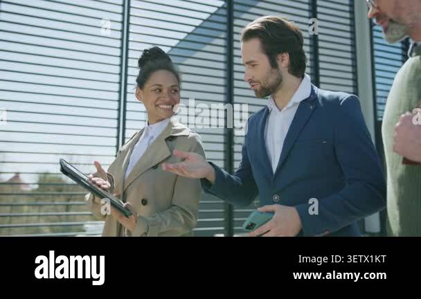 In this video, a man and woman interact in a professional setting by a ...