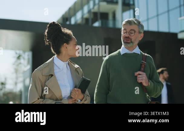 Close up two business people walking talking. Young woman have ...