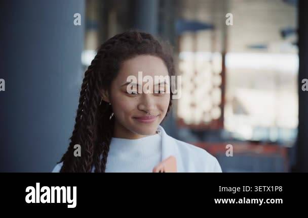 Happy attractive woman walking with mobile phone. Smiling, talking on ...