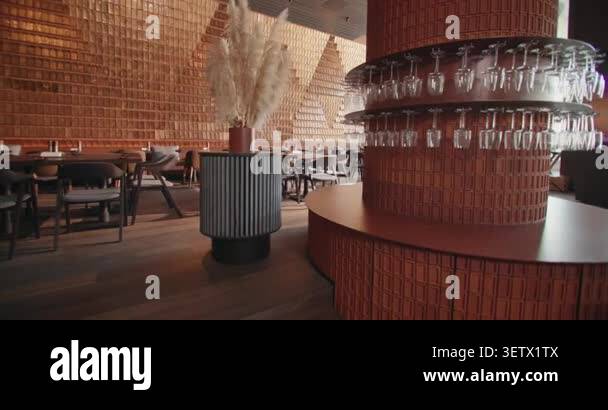 A cozy restaurant with a stylish interior, rustic brick wall, and ...