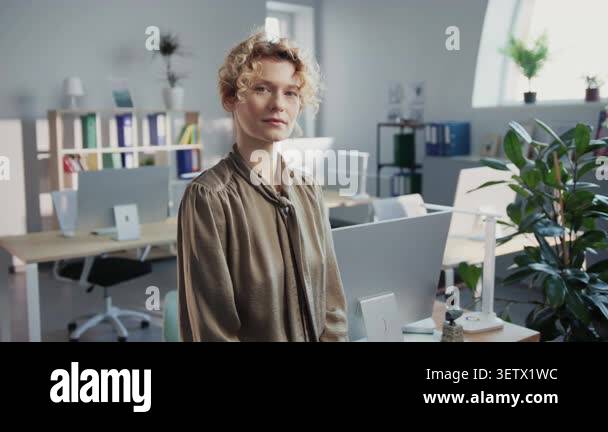 Portrait of smiling female company owner in background of modern cozy ...
