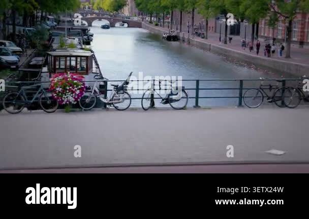 Amsterdam Canal Bridge With Bicycles And Hanging Flowers. High quality ...