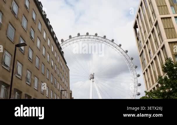 London Eye Observation Wheel Framed Between Tall Buildings. High ...