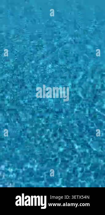 Swimming pool with clear blue water at a sunny summer hotel on June 20 ...