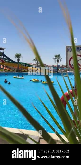 Water park pool with no jumping sign and inflatable floats on June 20 ...
