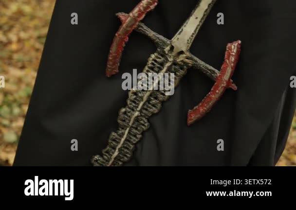 Worn sword, Mystical forest, Cloaked warrior. Person shrouded in dark ...