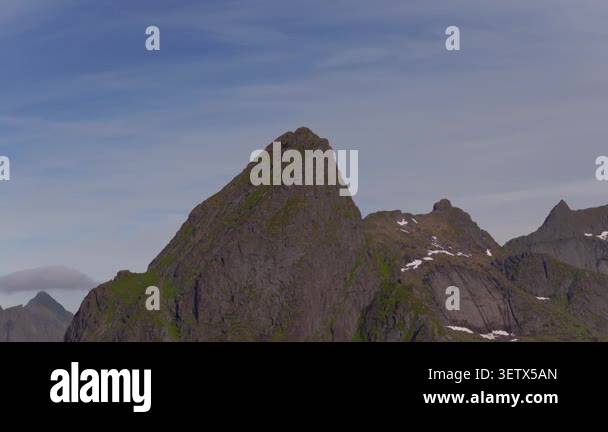 Majestic jagged mountain peaks in Lofoten, Norway with moss-covered ...