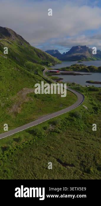 Aerial view of winding coastal road through green mountainous terrain ...