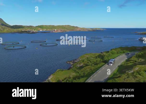 Aerial view of salmon fish farm with circular net cages in deep blue ...