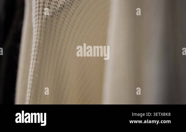 Soft white knitted textile showing delicate weave structure, minimalist ...