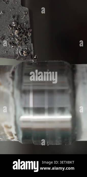 Cutting tool shaping rotating metal surface on industrial lathe machine ...