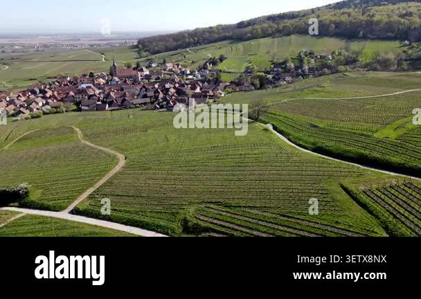 Aerial drone view over a half-timbered Alsace village with a church ...