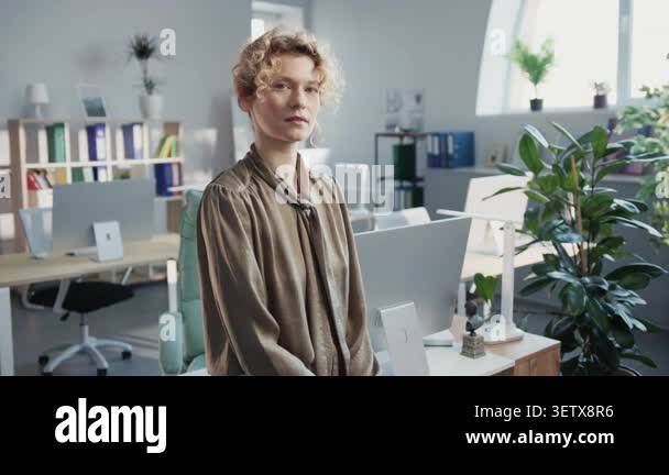 Shot of serious business woman looking away in background of modern ...