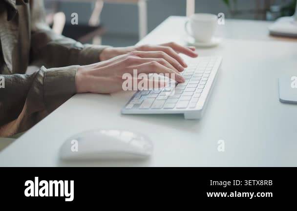 Focused senior lawyer in classy blouse typing article on keyboard ...