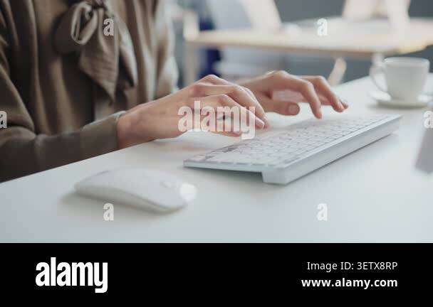 Close-up of Caucasian female hands typing text on keyboard. Business ...