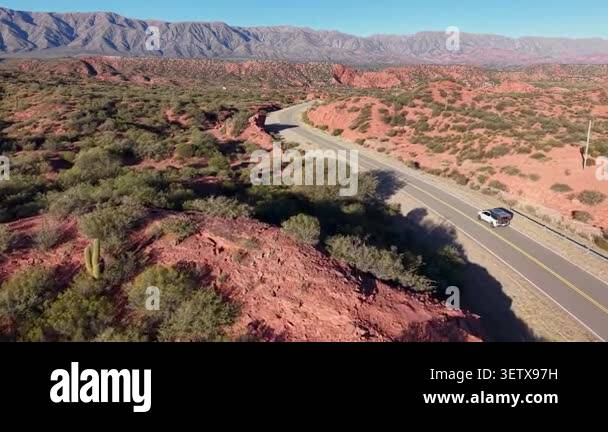 Drone shot of overland vehicle traveling through remote mountain ...