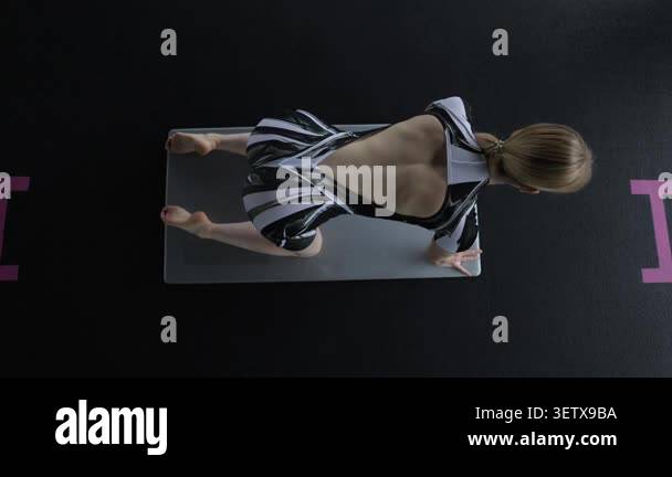 Athletic woman with a strong back performing the cat-cow yoga stretch ...
