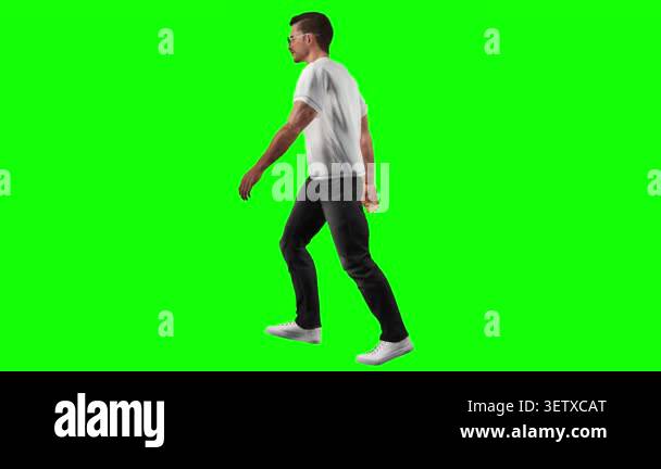 Side view of male model walking with relaxed catwalk style on green ...