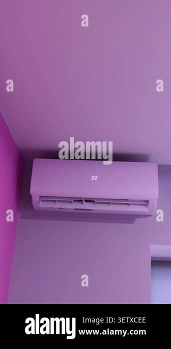 Air conditioner on pink wall cooling room close up. Vertical lifestyle ...