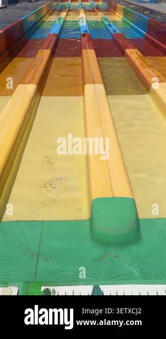 Rainbow multi lane water slide at a sunny outdoor water park on June 20 ...