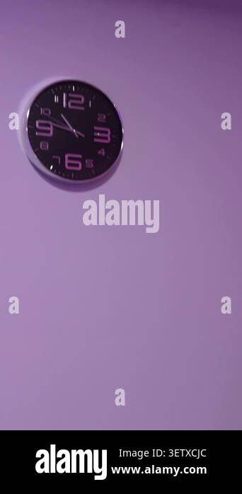 Wall clock on purple background with copy space. Vertical layout of ...