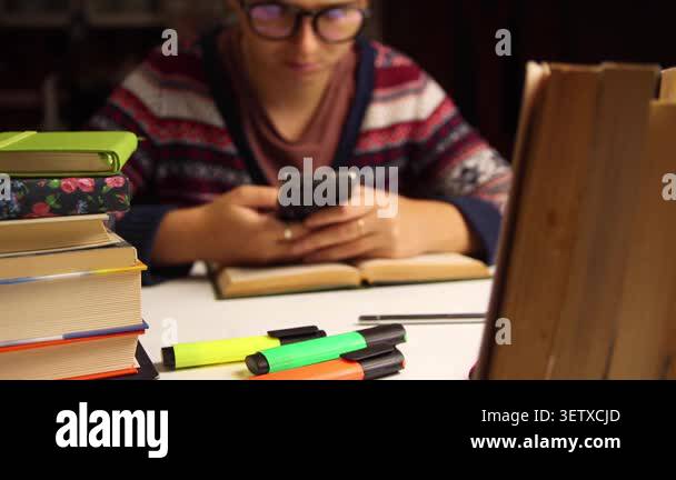 Student using smartphone instead of studying close up. Female student ...