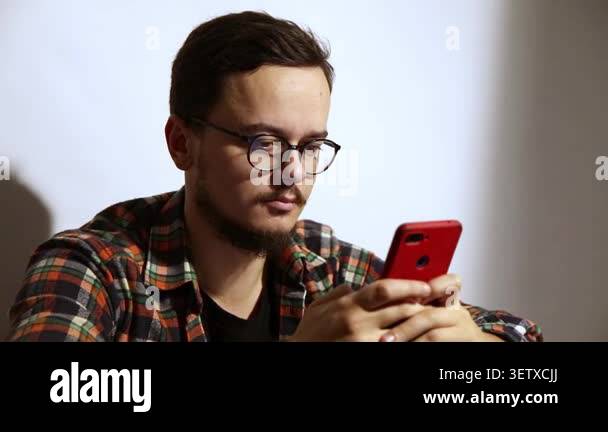 Man using smartphone scrolling screen close up. Focused young guy with ...
