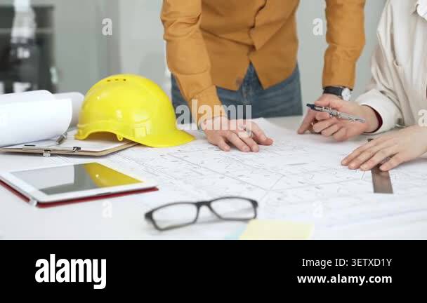 Architects and engineers collaborating on building development ...