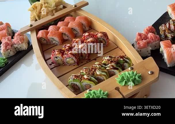 Beautiful wooden sushi ship filled with Philadelphia rolls avocado ...
