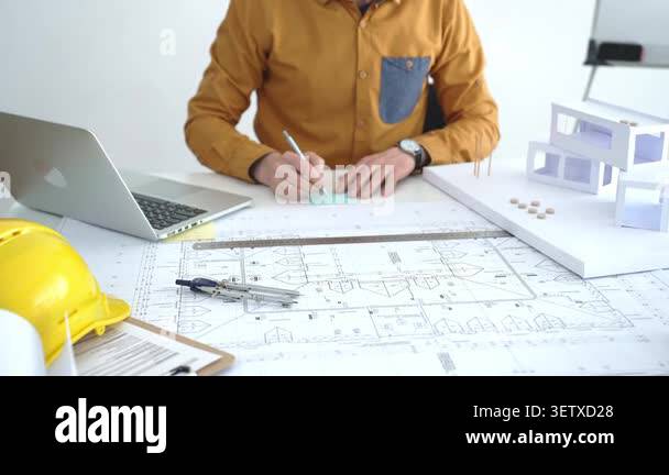 Architect creating a residential house plan, managing a building ...