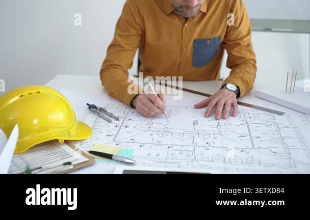 Architect or engineer meticulously drawing and analyzing detailed ...