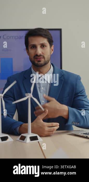 Portrait of Hispanic man engineer presents renewable power generation ...