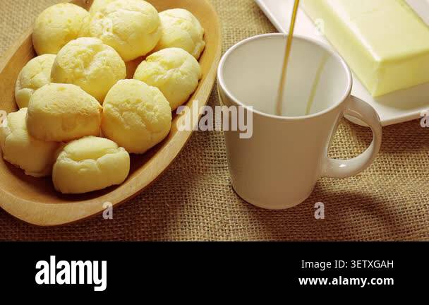 Authentic Brazilian cheese bread served with butter on a rustic burlap ...