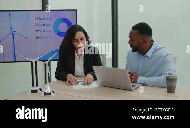 Portrait of Latin businesswoman reviews renewable energy data with ...
