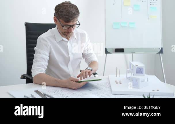 Architect brainstorming innovative construction concepts, tapping a ...