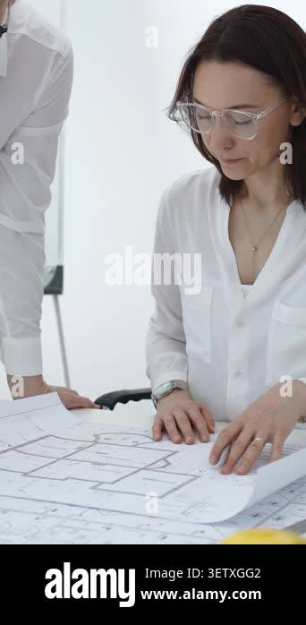 Professional architects working together on a blueprint, reviewing ...