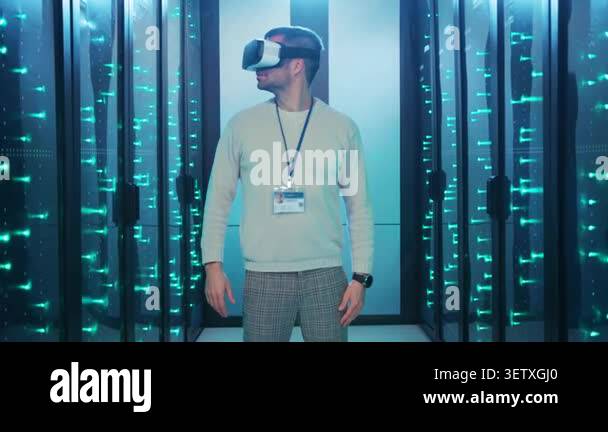 A man in a large, hightech server room is wearing a cuttingedge virtual ...
