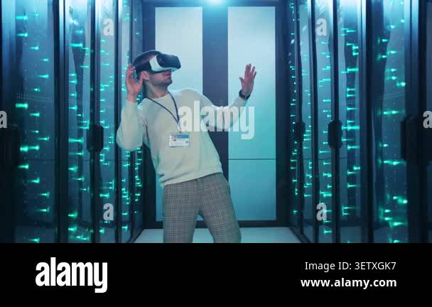 A man is currently wearing a virtual reality headset while he is ...