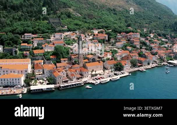 Aerial view perast waterfront historic quay, orange tiled roofs lining ...