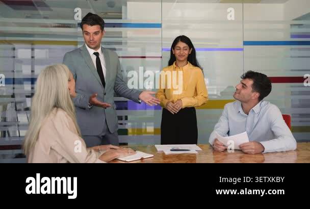Diverse business team leader man expressing recognition to Indian ...