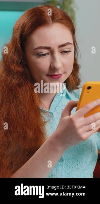 Happy redhead woman use mobile smartphone typing browsing say Wow yes ...