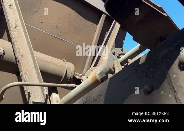 Low-angle close-up of an old freight railcar, riveted steel, peeling ...