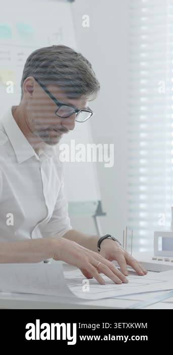 Architect hands designing blueprints for a new construction project ...