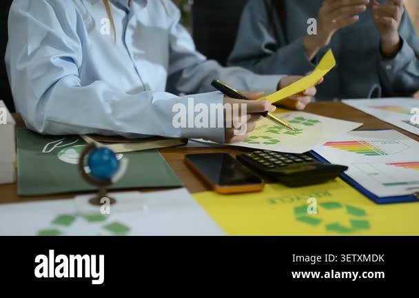 young asian woman in green shirt, working on a project, holding a ...