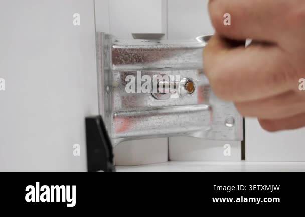 Close up of worker tightening metal fastener during installation ...