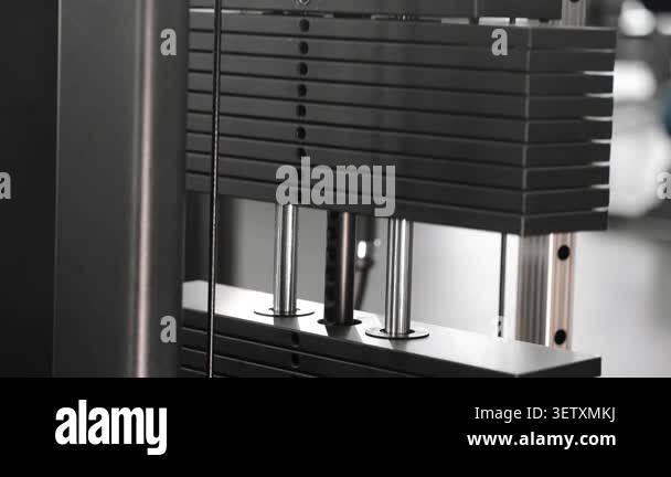 Close up of weight stack plates moving on resistance machine during ...