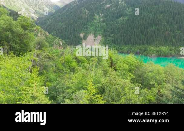 Aerial panoramic view of a stunning turquoise mountain lake surrounded ...