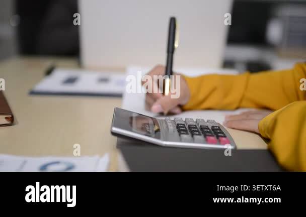 business people using calculator to calculate and financial accounting ...