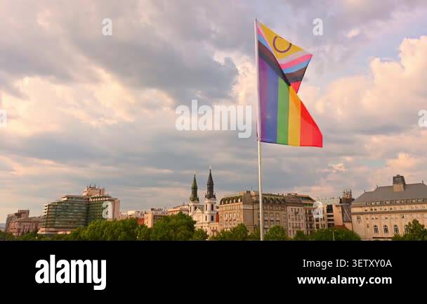 Budapest, Hungary - June 20, 2026. Progress Pride flag waving above an ...